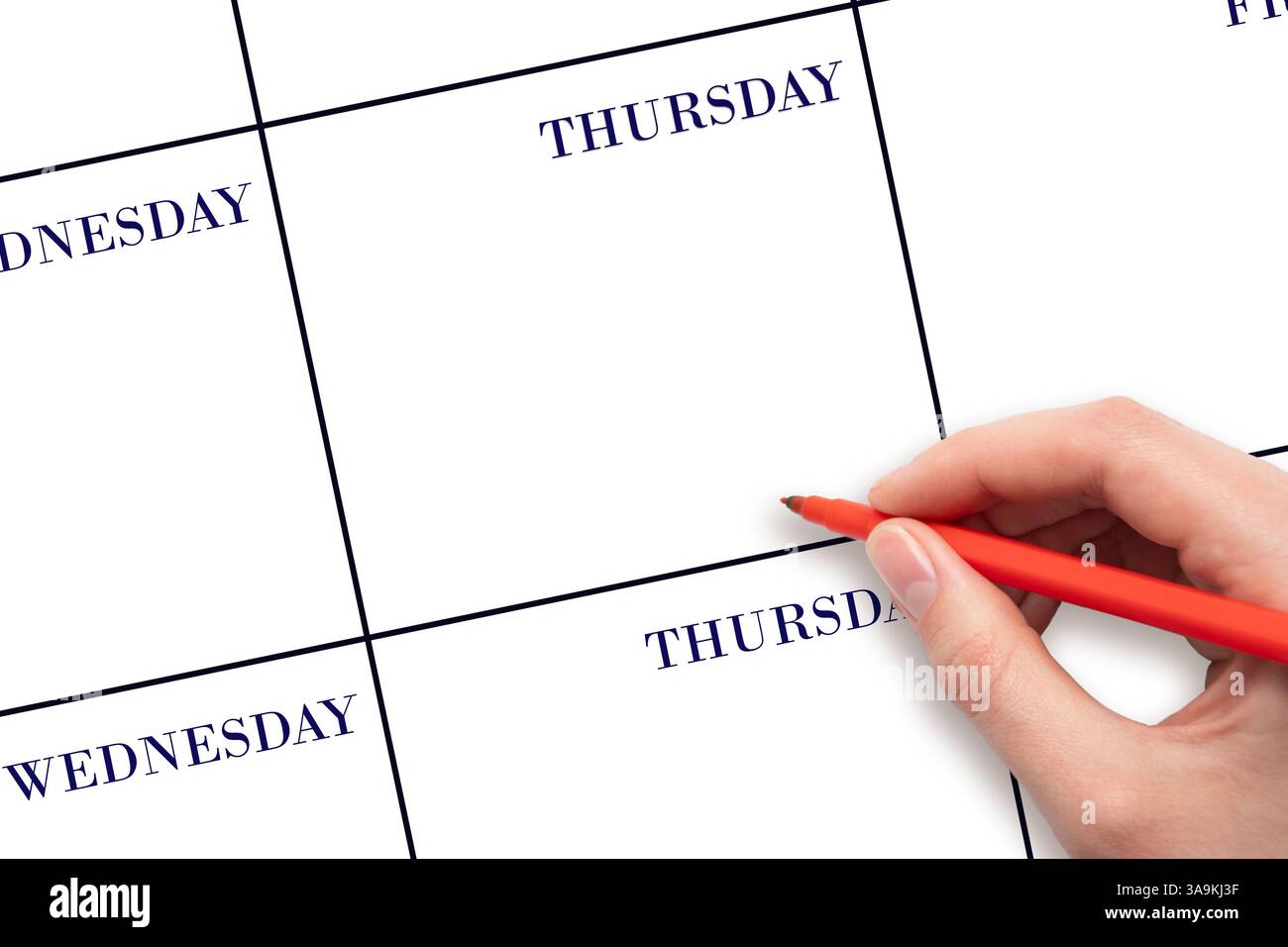 THURSDAY. Hand holding red pen writing in blank Thursday cell of a ...