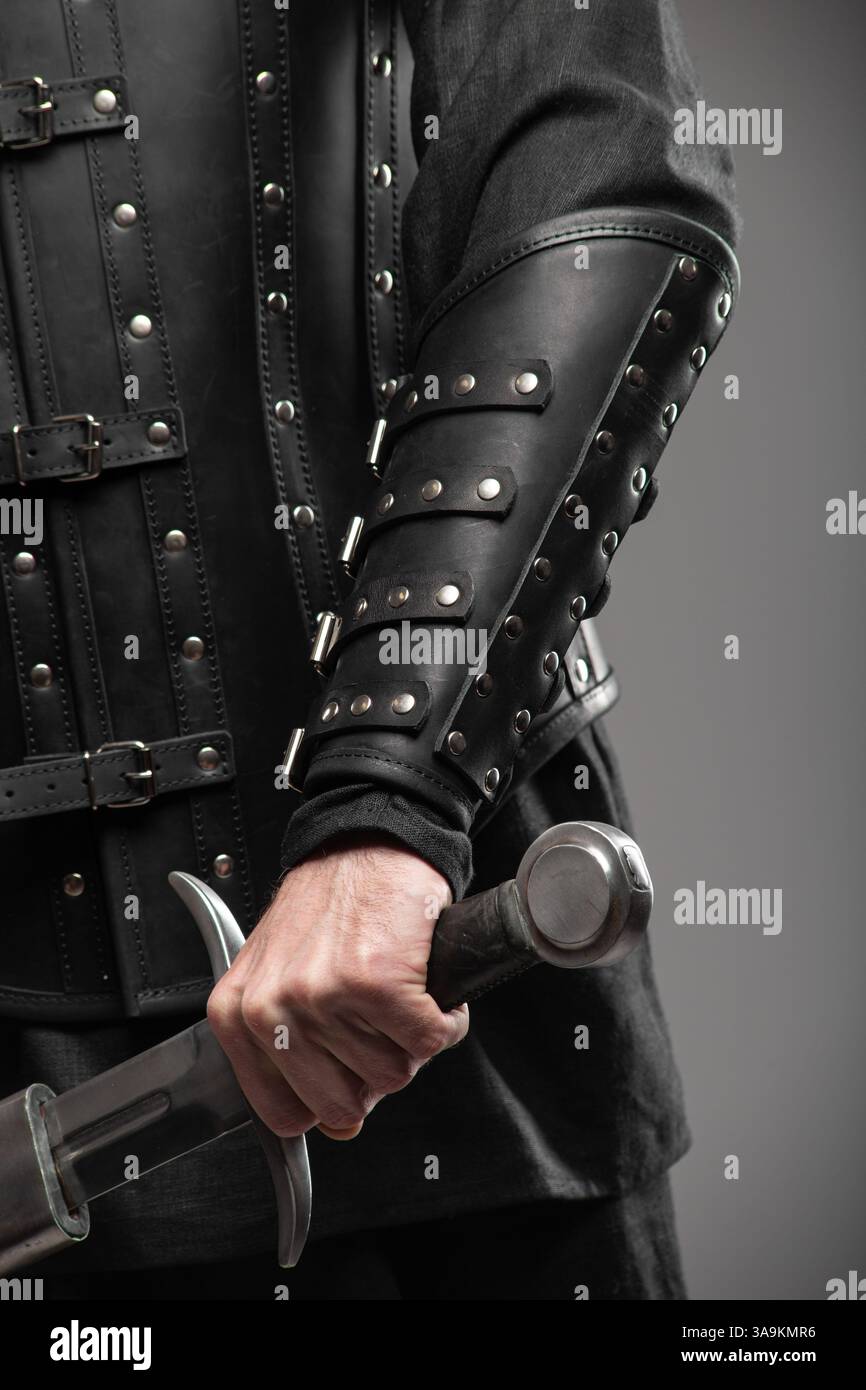 Person Wearing Black Widow Leather Bracers Holding Sword Stock Photo ...
