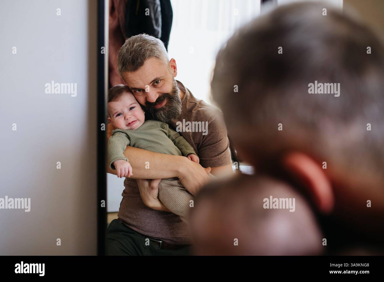Father comforting his crying baby son Stock Photo - Alamy