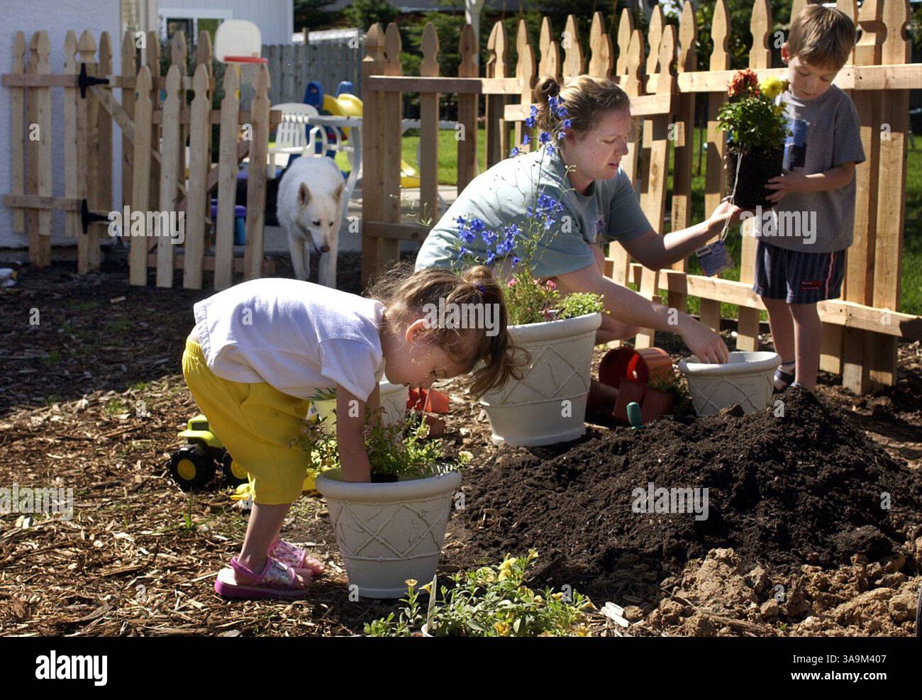 Jessica Chalk works on her garden with her daughter Faith Chalk, 3 ...