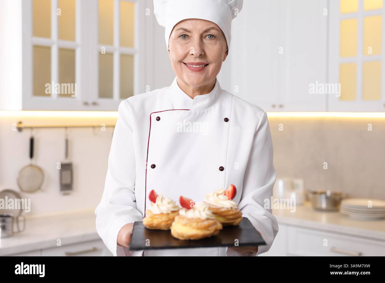 Professional pastry chef with desserts in kitchen Stock Photo - Alamy