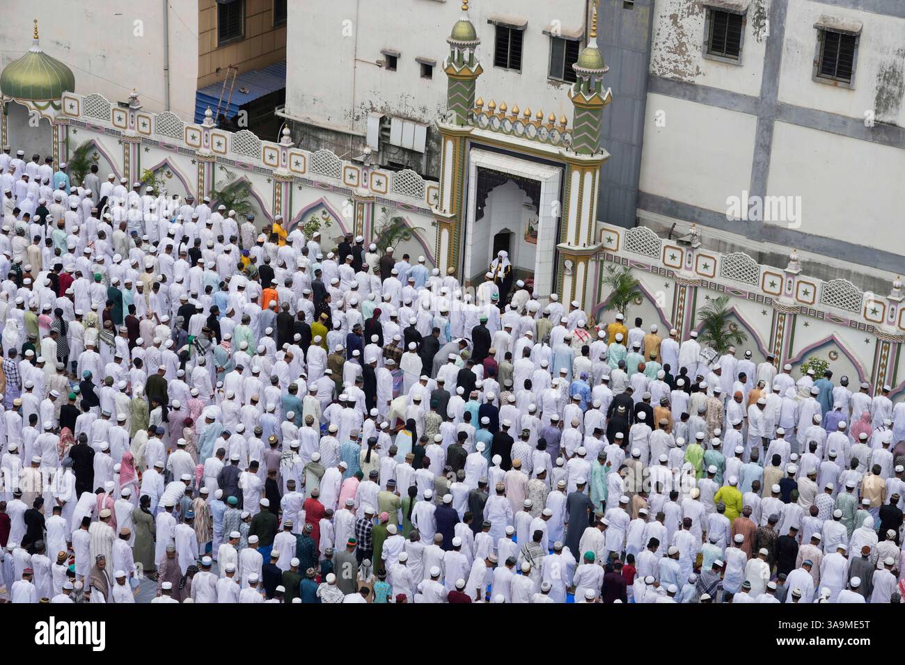 A Muslim cleric preaches as others wait to perform an Eid al-Fitr ...