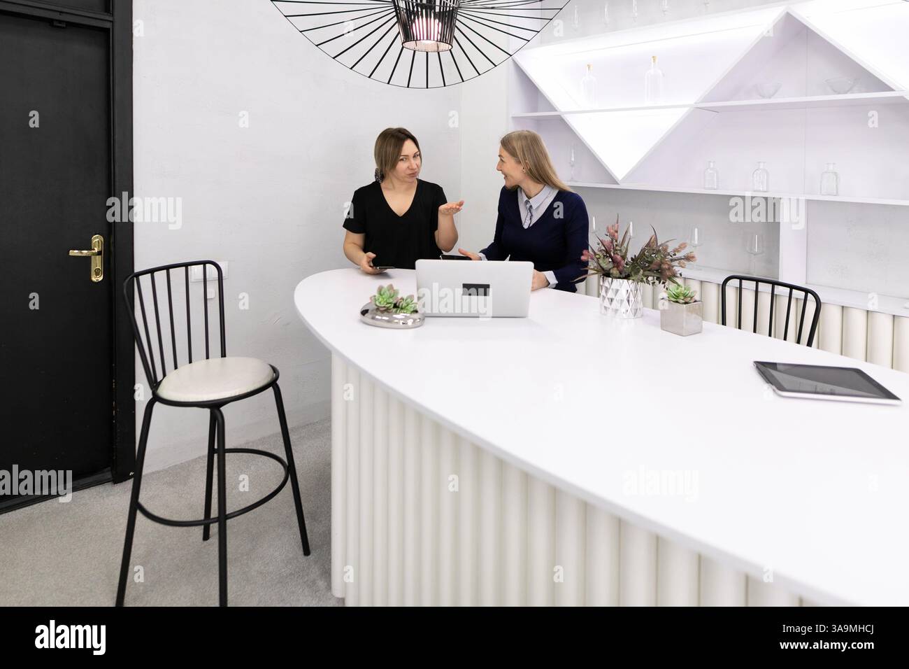 Creative brainstorming session between two women at a modern workspace ...