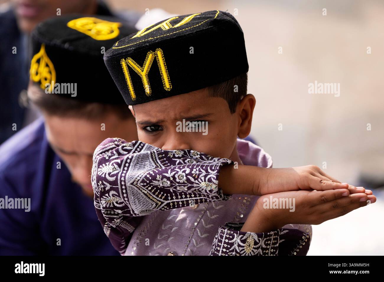 A Muslim child gestures as he takes part in an Eid al-Fitr prayer ...