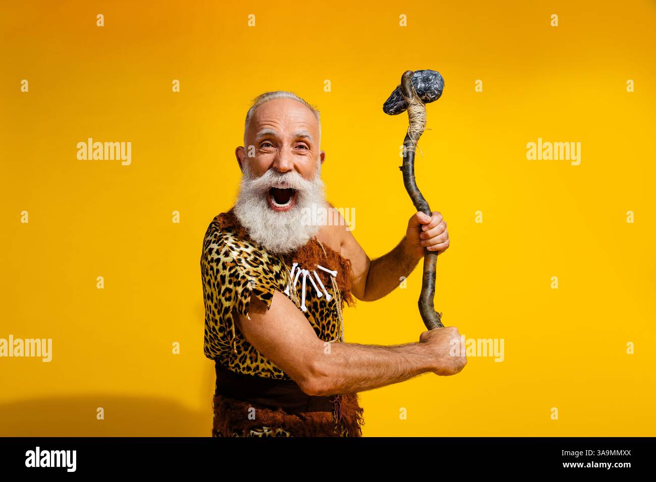 Photo of angry ancient cave man raise weapon tool rock scream wear ...