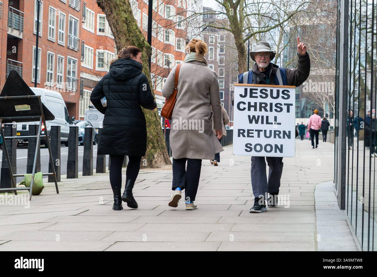 Jesus Christ will return soon, on a sandwich board of a senior white ...