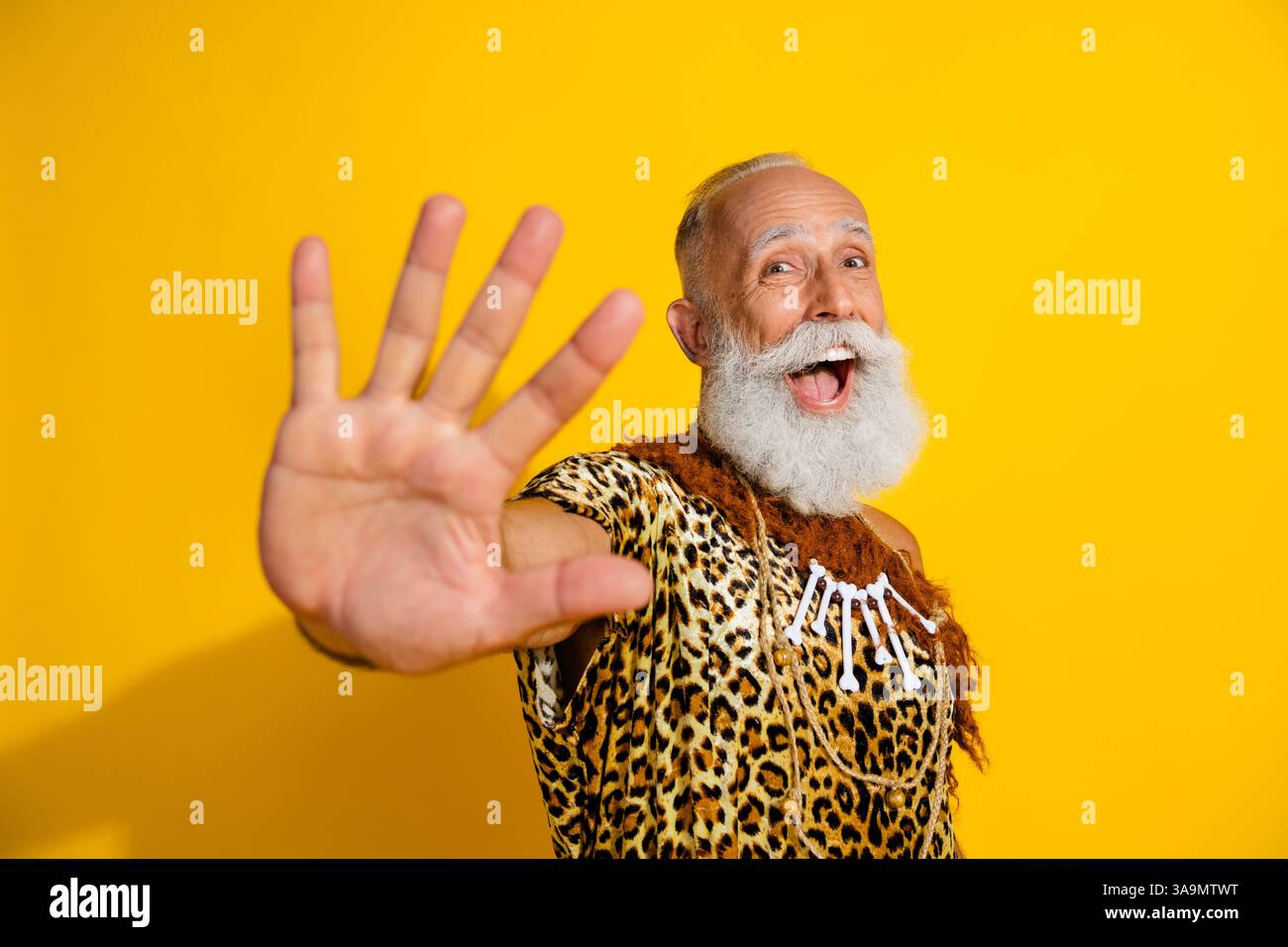 Photo of ancient aged caveman hand wave hi wear leopard skin clothes ...