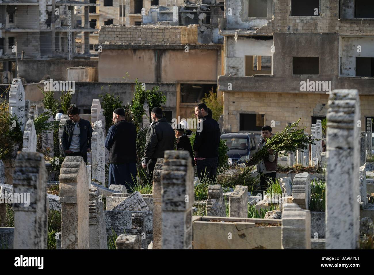 Idlib, Syria. 31st Mar, 2025. People visit the graves of their loved ...