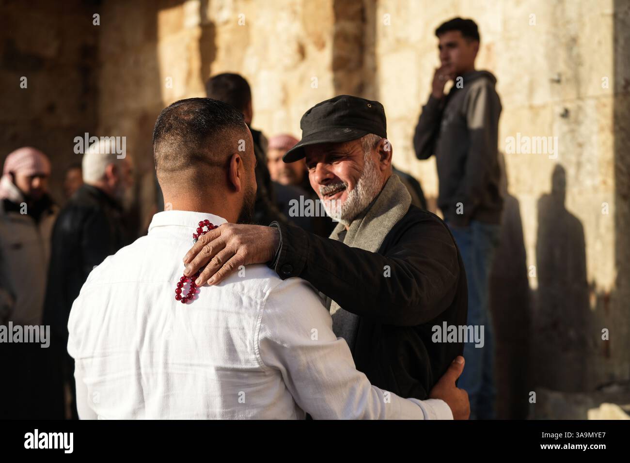 31 March 2025, Syria, Idlib: People greet eatch other as they arrive ...