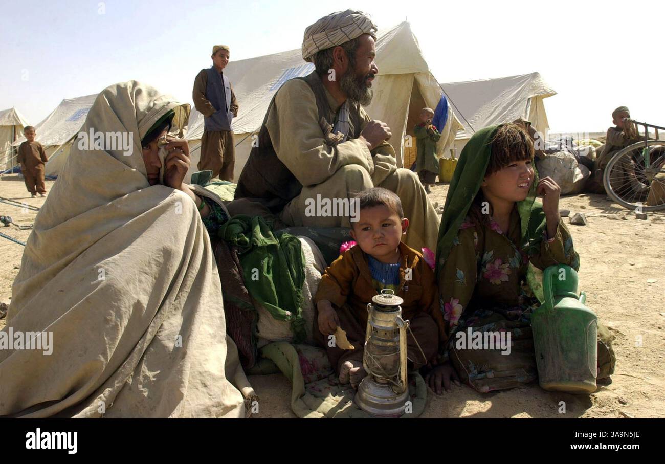 Oct 24, 2001; Chaman, PAKISTAN; An Afghan refugee family sits near ...