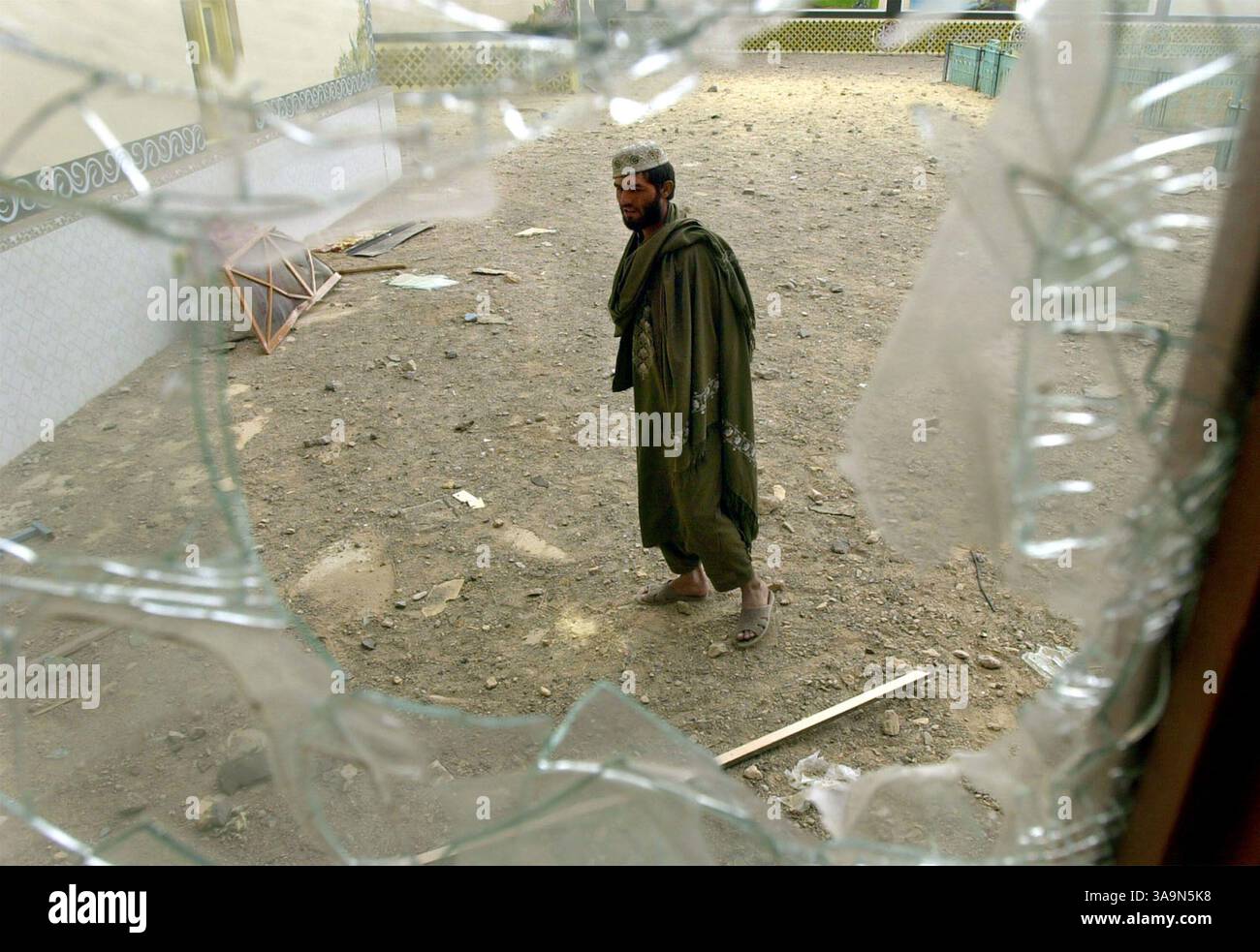 An Afghan man meanders through the bombed out remains of what was once ...