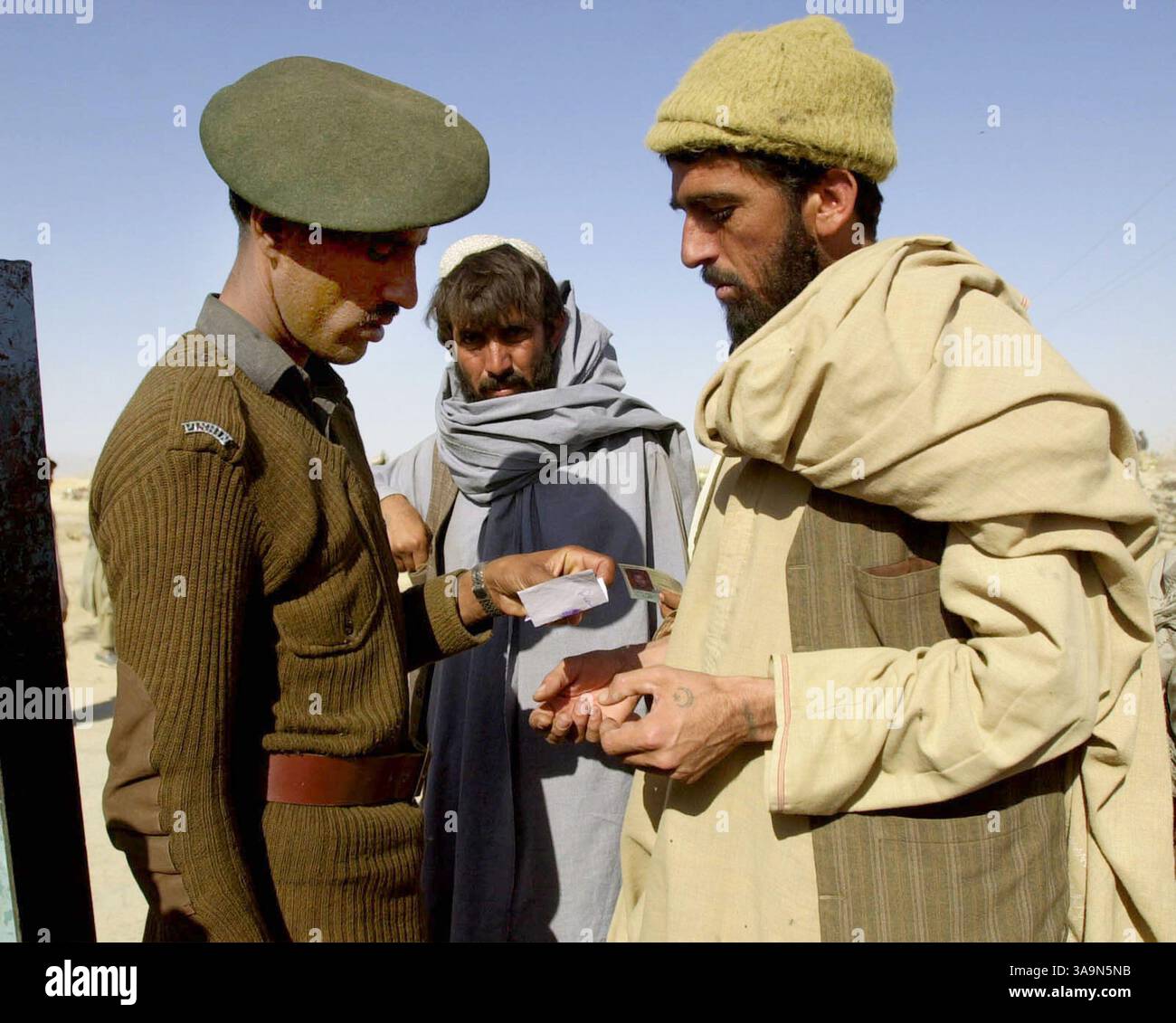 Nov 29, 2001 - Chaman, Pakistan - A Pakistani border guard checks the ...