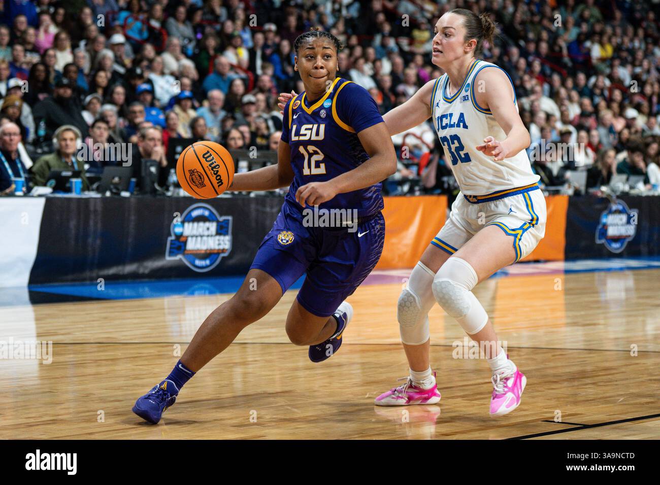 LSU Tigers guard Mikaylah Williams (12) drives past UCLA Bruins forward ...