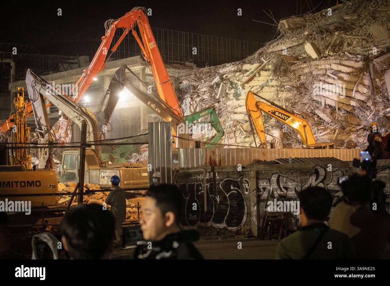 Rescue teams work tirelessly amidst the rubble of a collapsed ...