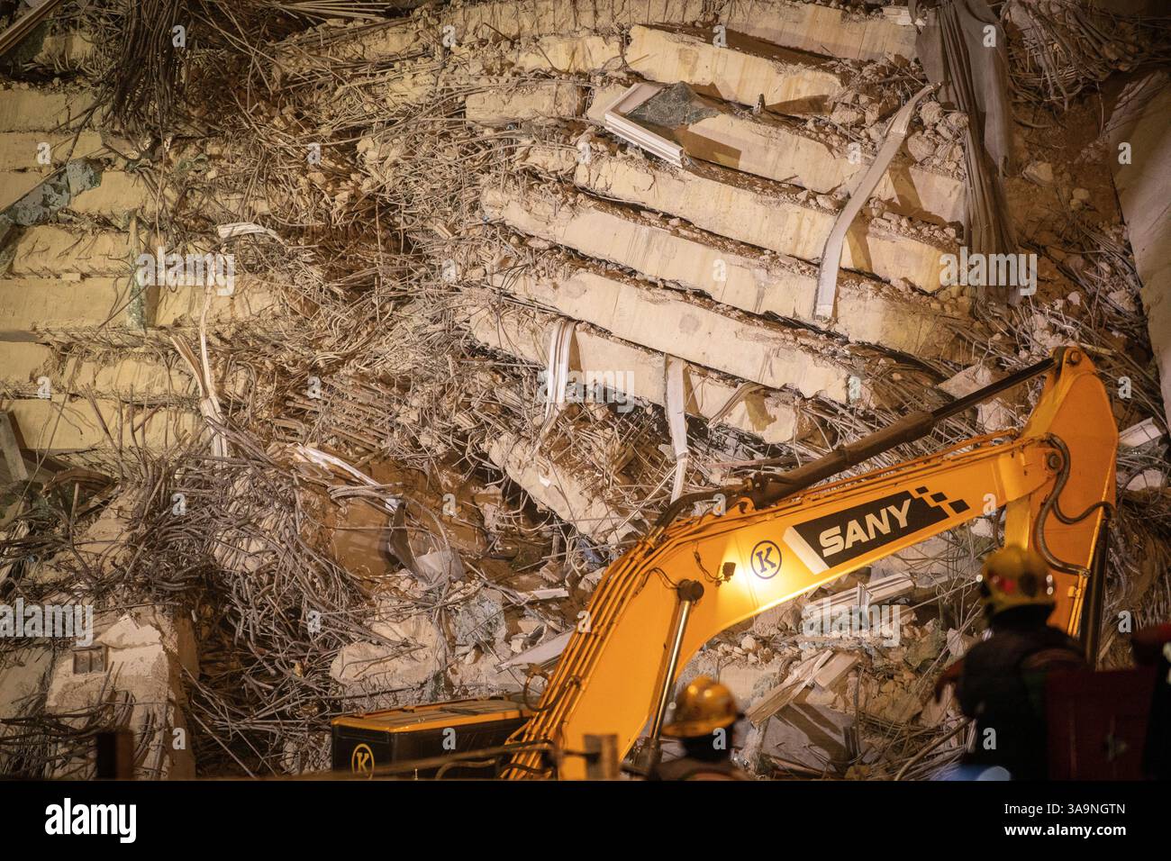 Rescue teams work tirelessly amidst the rubble of a collapsed ...