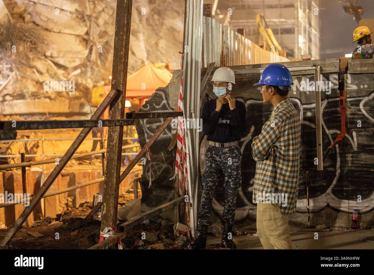 Rescue teams work tirelessly amidst the rubble of a collapsed ...