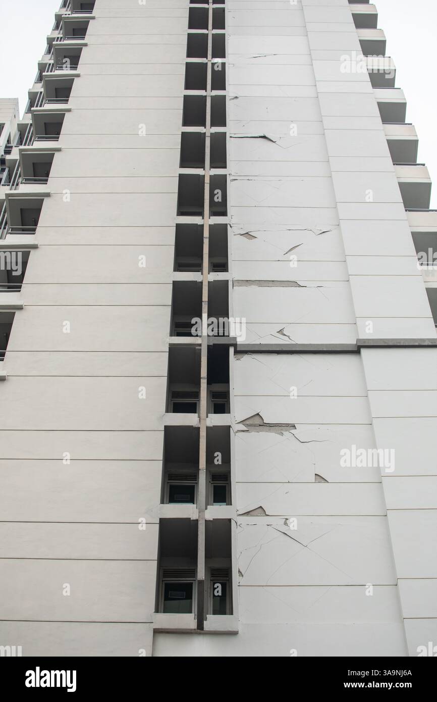 Jagged cracks scar the exterior of a high-rise condominium in Bangkok ...
