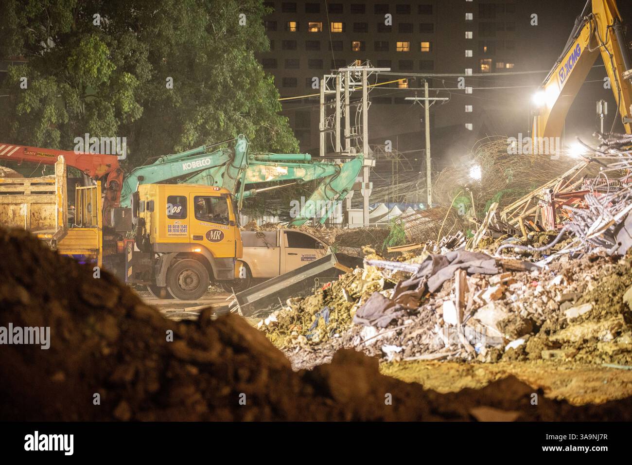 Rescue teams work tirelessly amidst the rubble of a collapsed ...