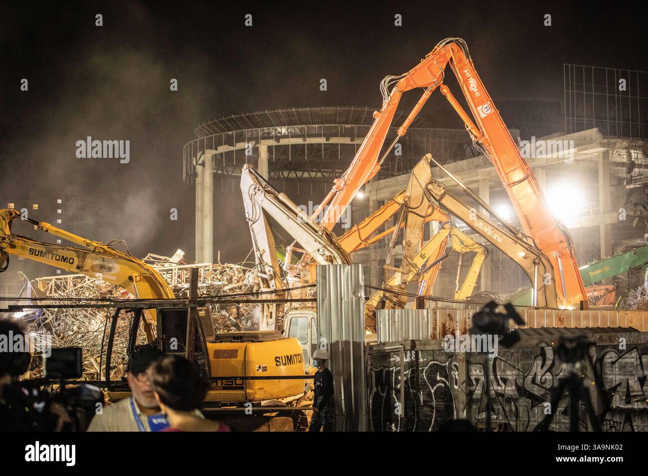 Rescue teams work tirelessly amidst the rubble of a collapsed ...