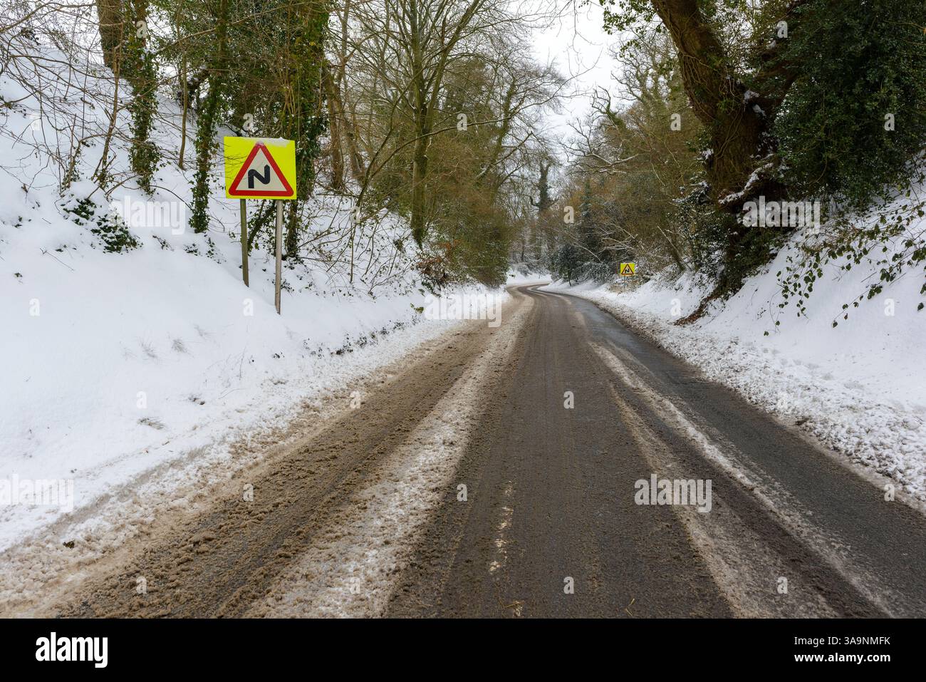 Z bend sharp bends road sign and steep hill with snow Stock Photo - Alamy
