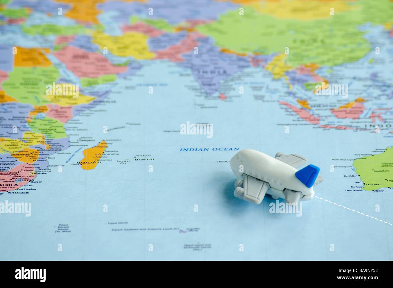 Small airplane placed on a world map heading to its destination Stock ...