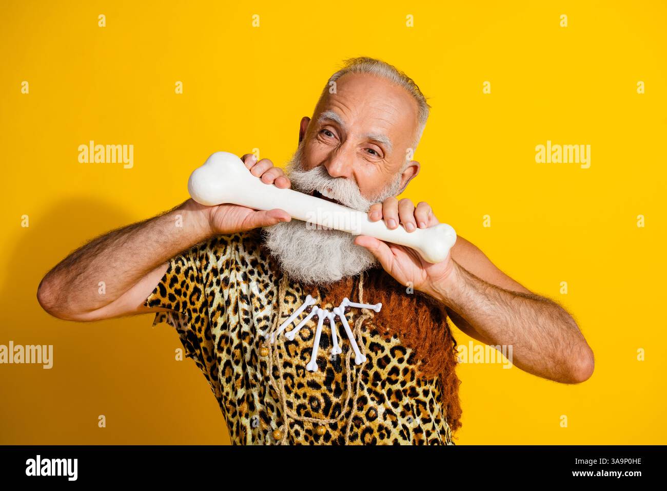 Portrait of primeval caveman eat bone wear leopard skin clothes ...