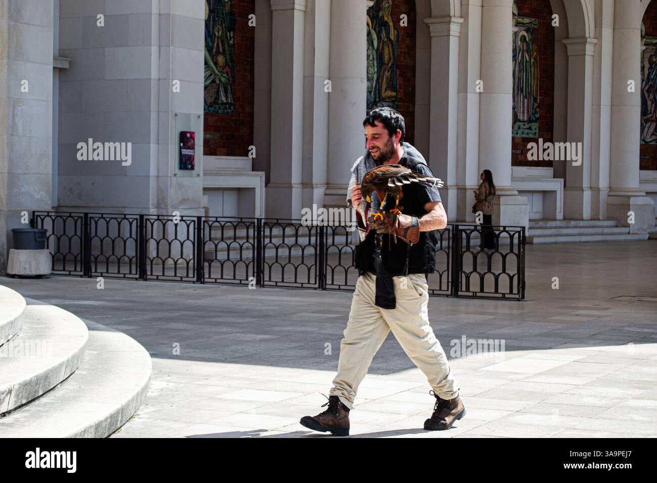 Fatima, Portugal - March 26, 2025: A man carrying a hawk showcases ...