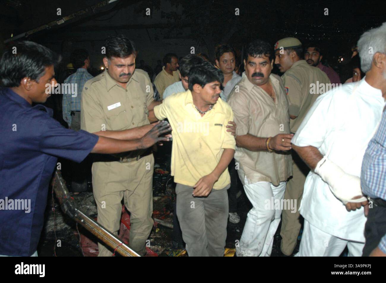 Oct 29, 2005; New Delhi, INDIA; Indian police and residents work at the ...