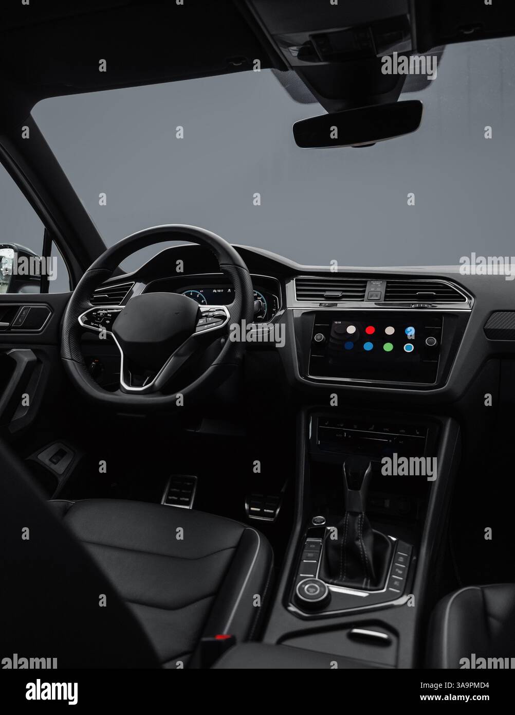 Modern car interior with dark grey accents. Steering wheel and ...