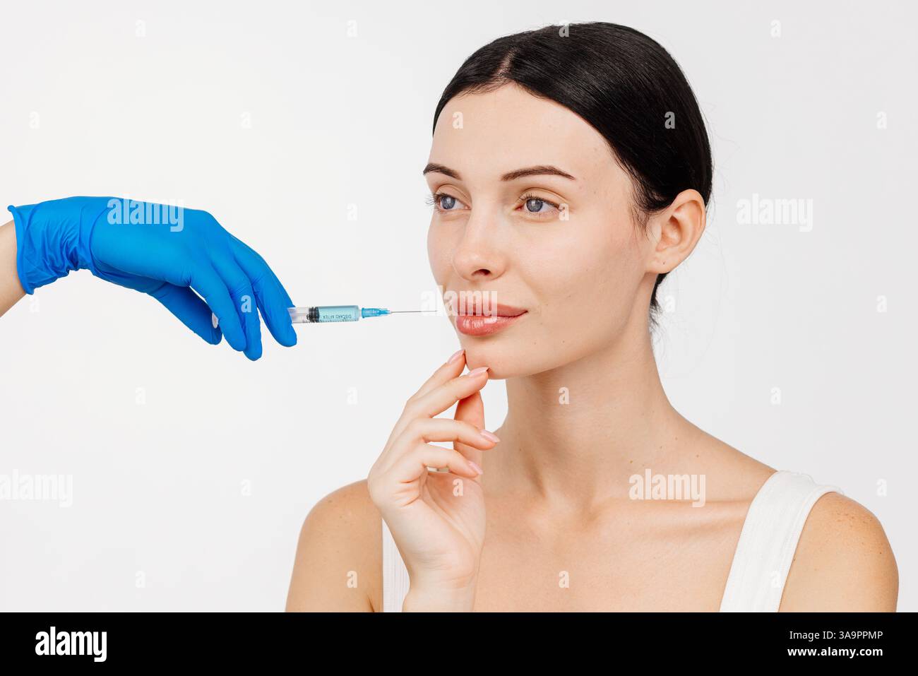 Botox injection against a white studio background. The close-up ...