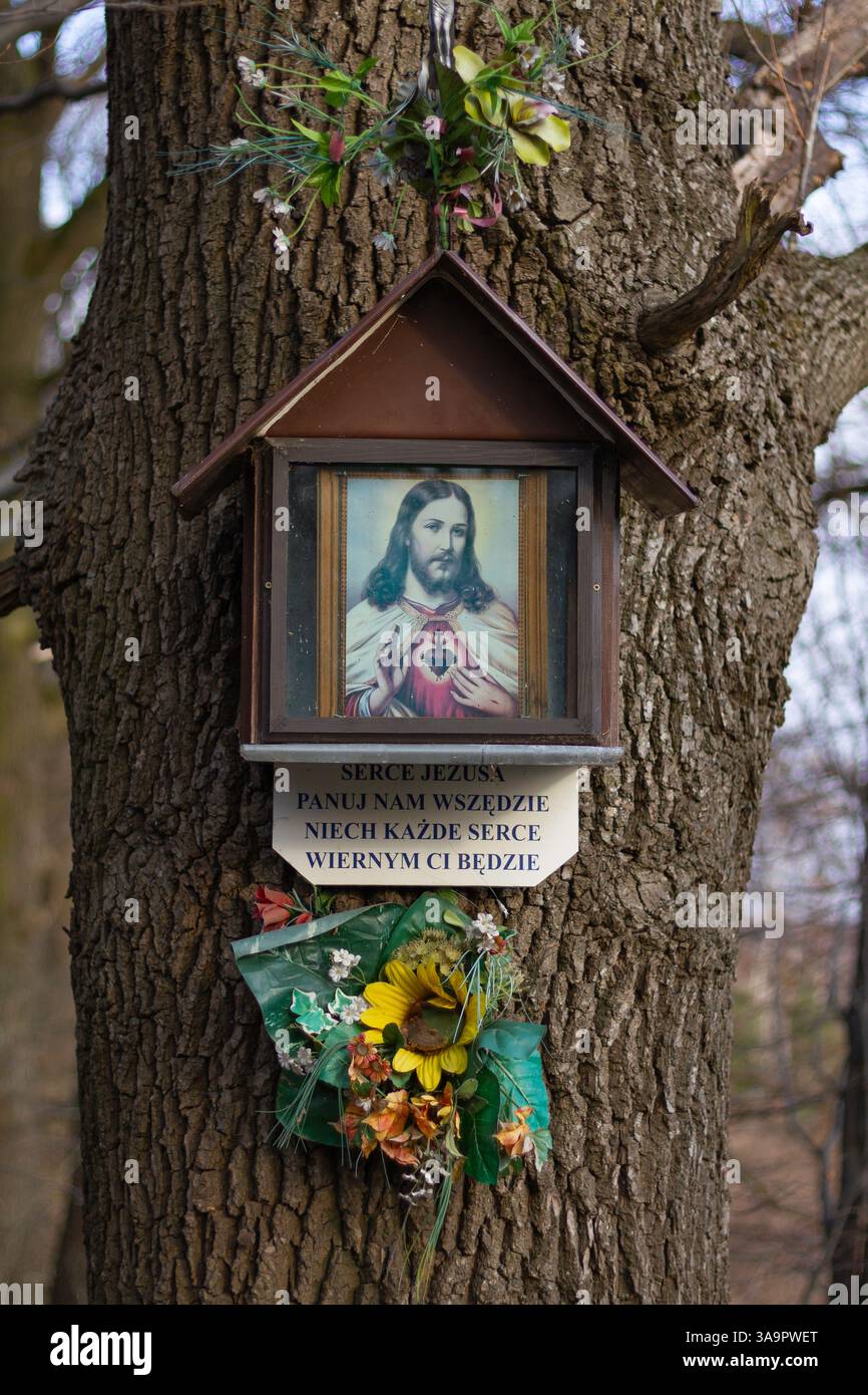 A small wooden box with a picture of Jesus Christ on it is hanging from ...