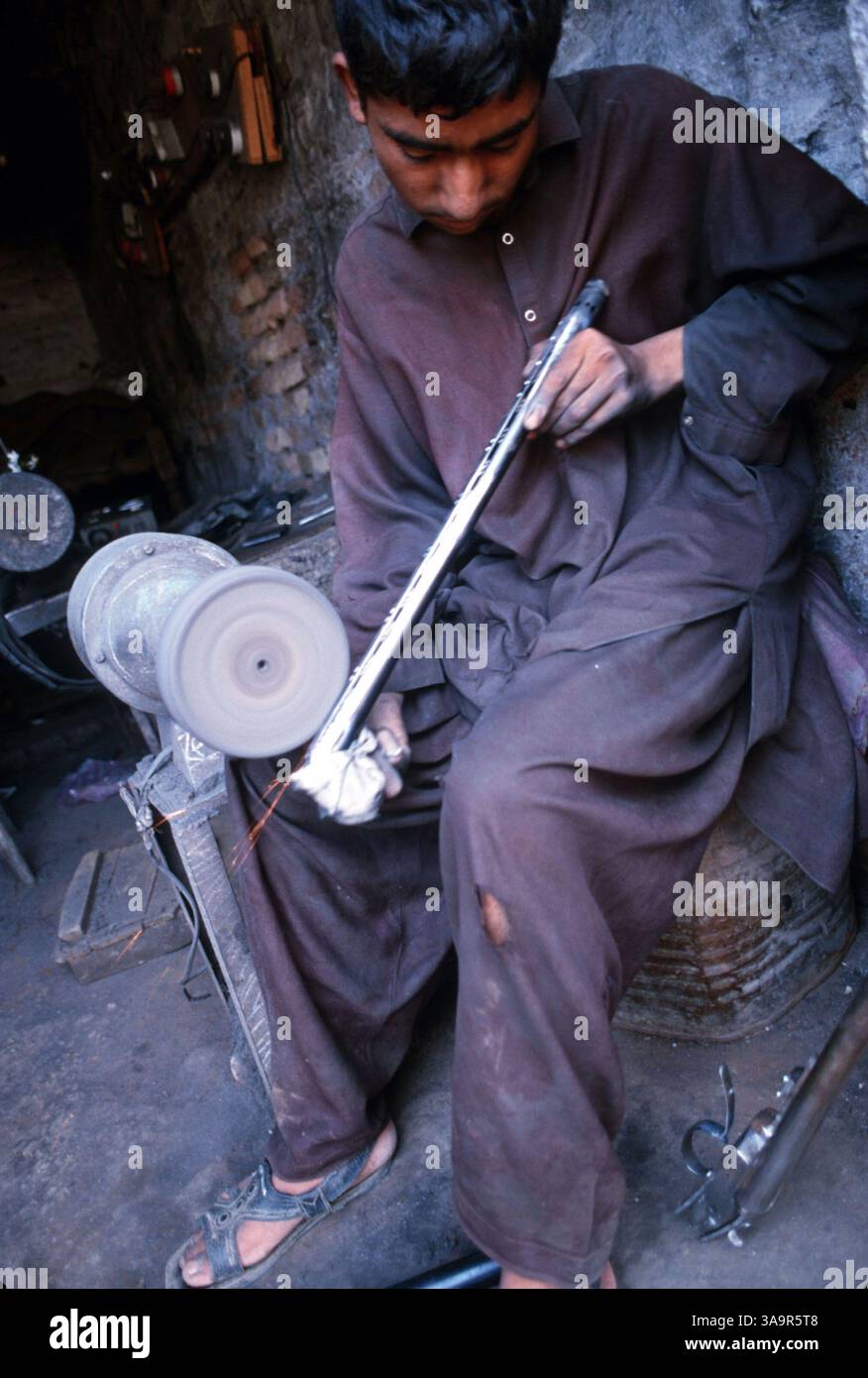 Oct 09, 2000; Darra Adam Khel, PAKISTAN; A gun barrel maker examines a ...