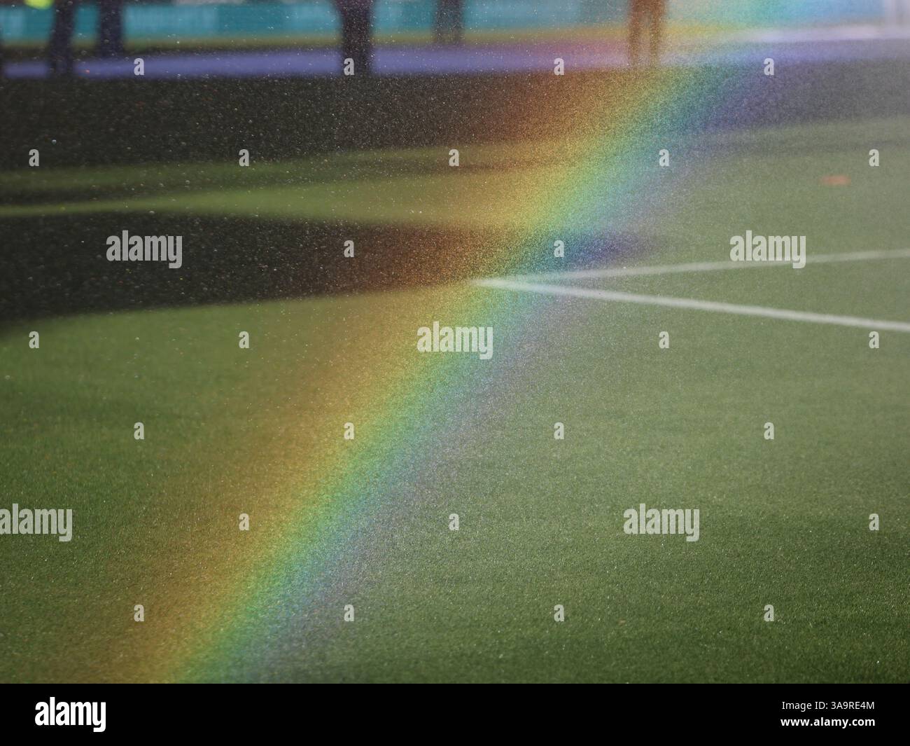 Rainbow effect on a football field while it's being watered Stock Photo ...