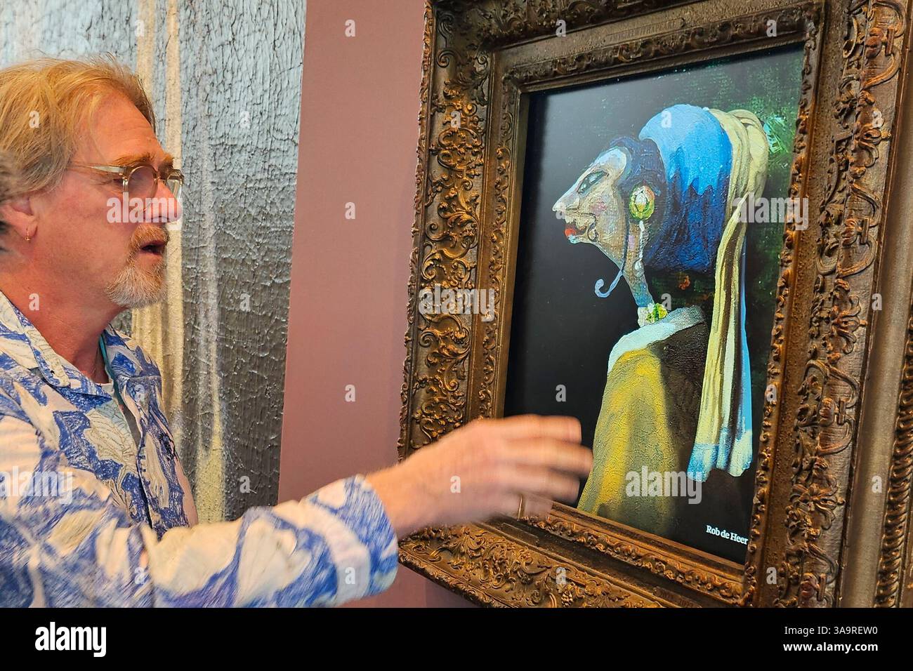 Rob de Heer talks next to his artwork, one of 60 pieces exhibited and ...