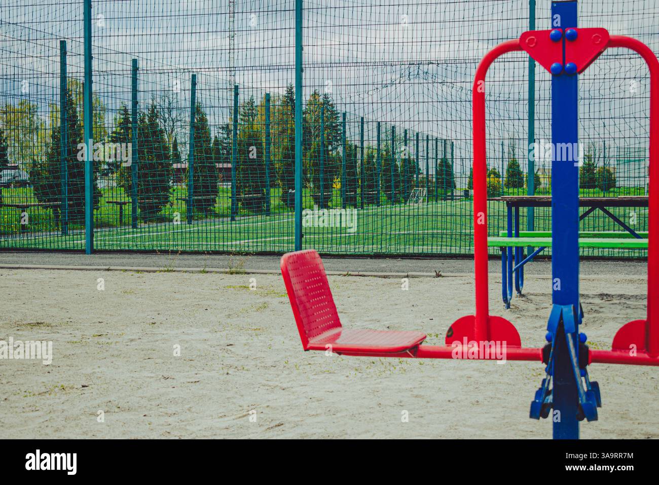 Outdoor playground with simulators. A football field enclosed mesh ...