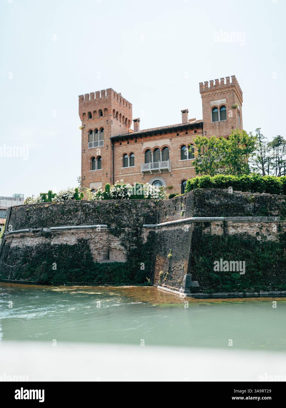 Exploring Treviso's enchanting castle along the serene river on Stock ...