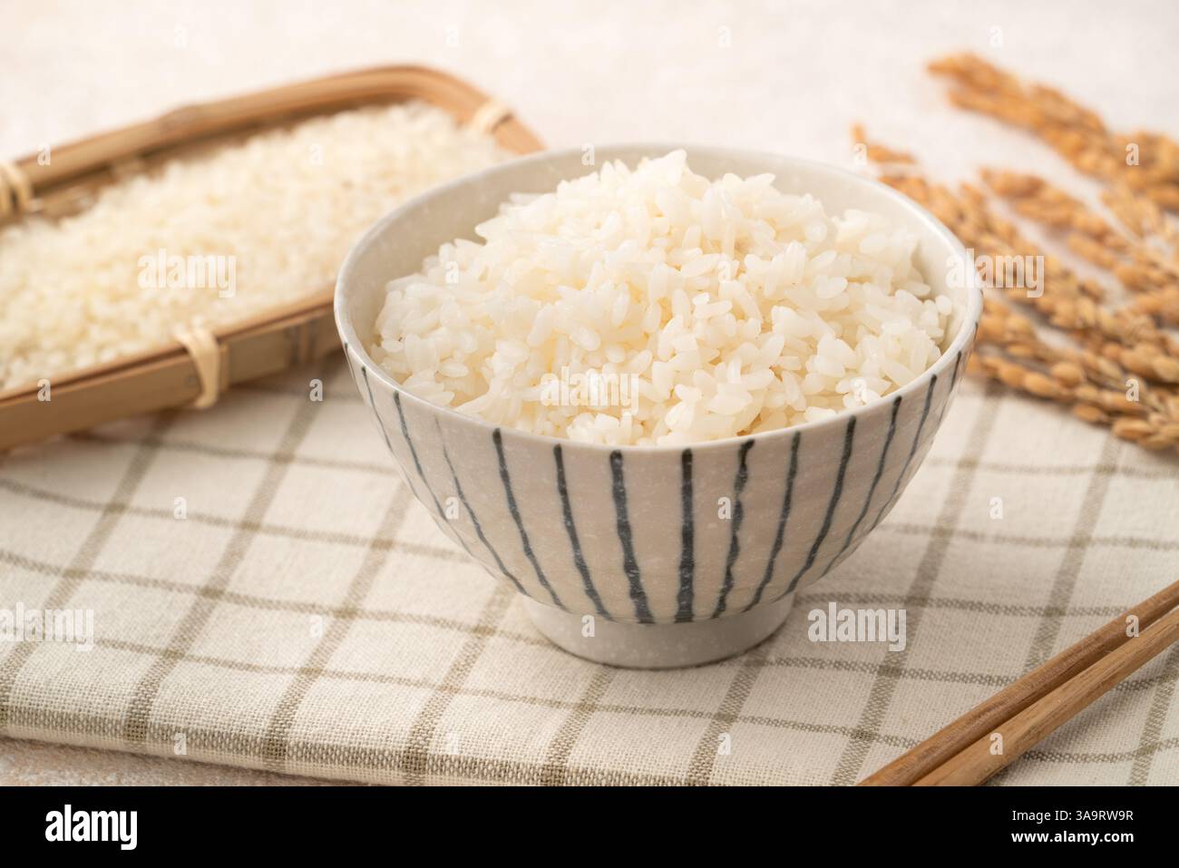 A bowl of freshly cookd steamed white rice, soft, fluffy, and slightly ...