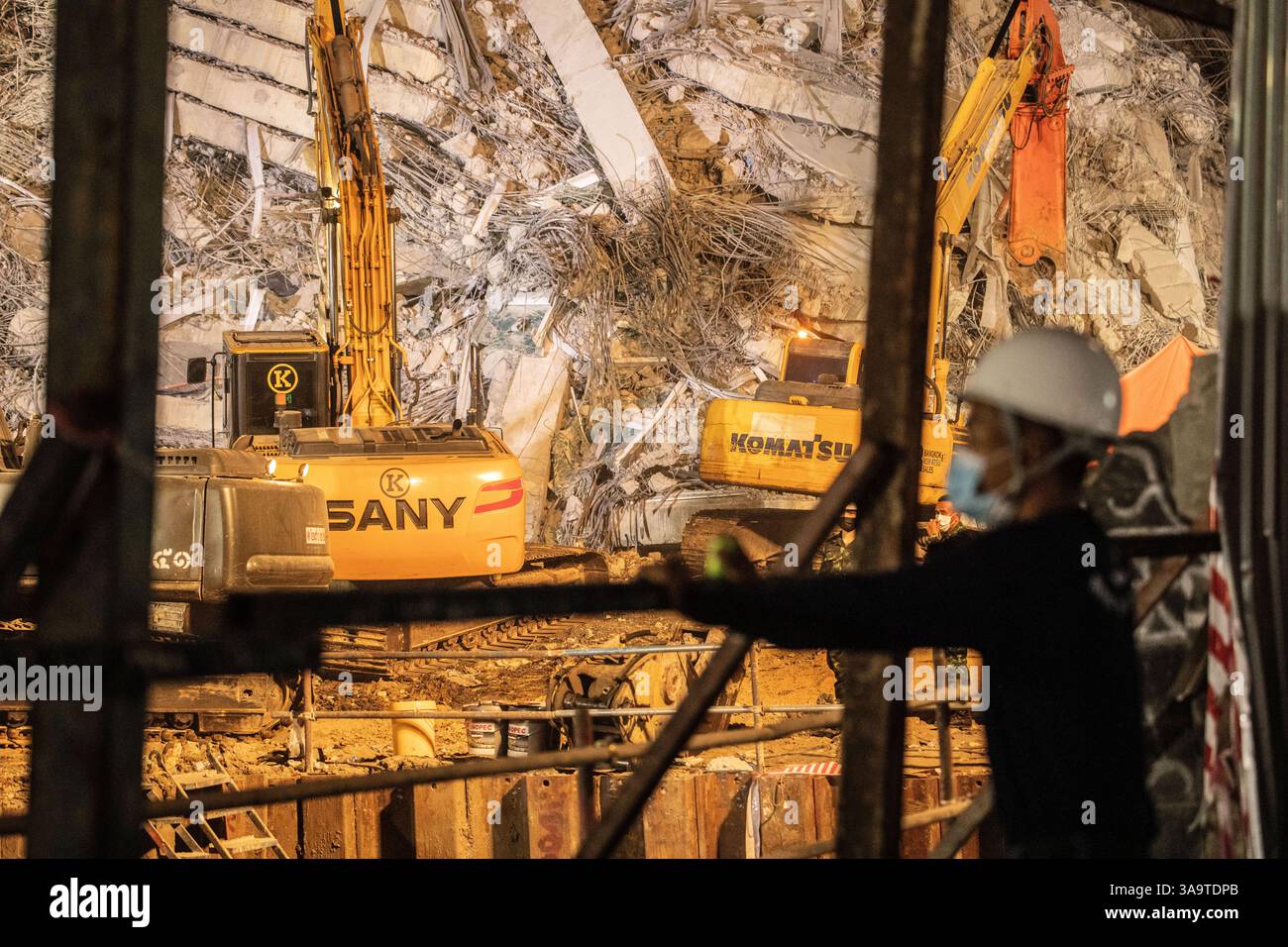 Rescue teams work tirelessly amidst the rubble of a collapsed ...