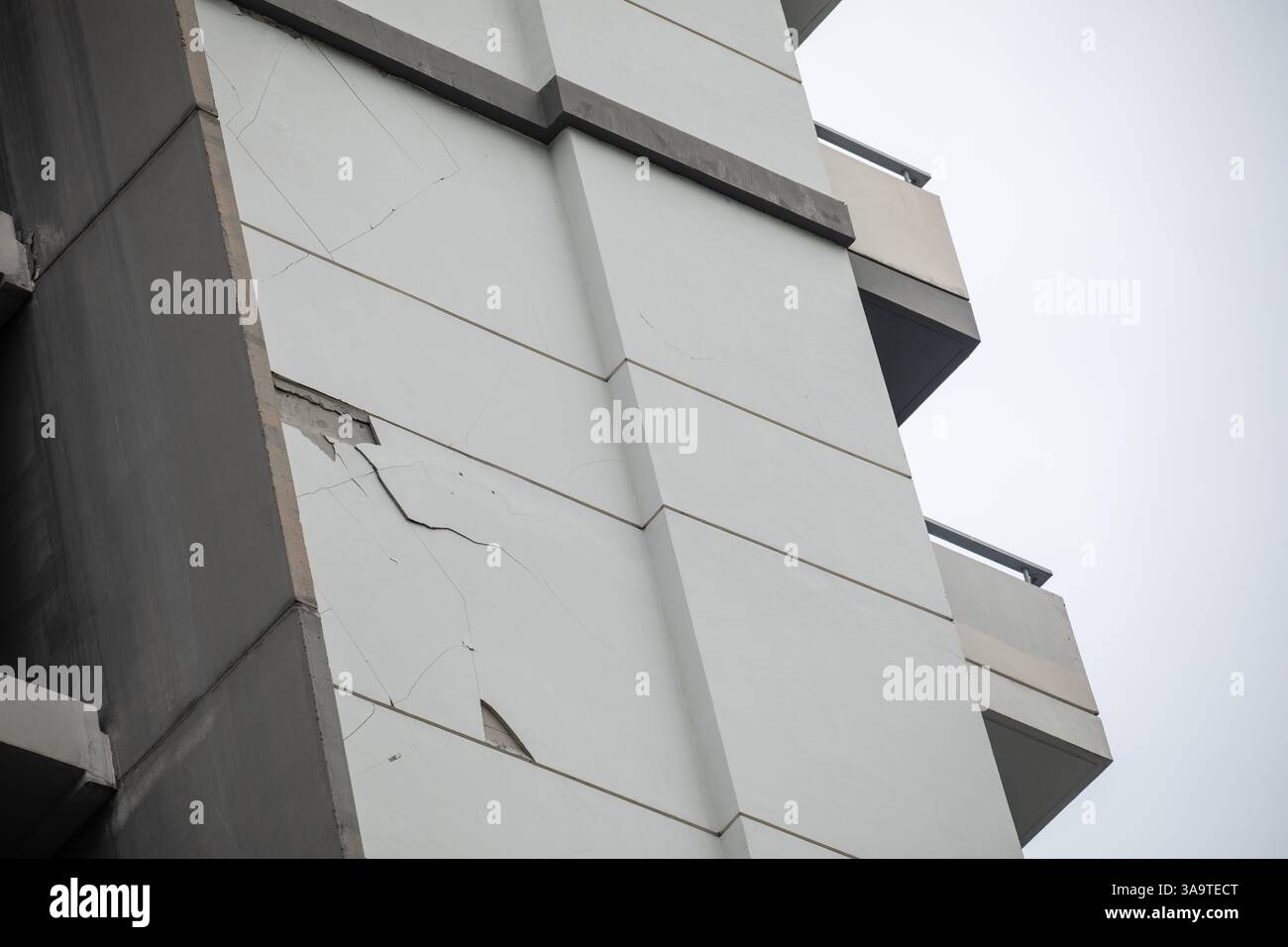 Jagged cracks scar the exterior of a high-rise condominium in Bangkok ...