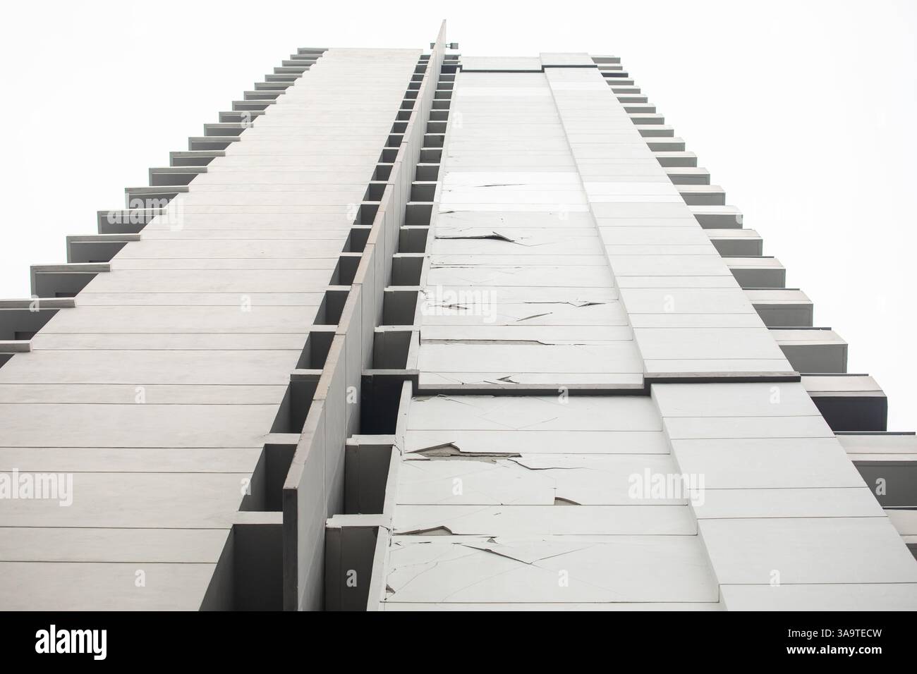 Jagged cracks scar the exterior of a high-rise condominium in Bangkok ...