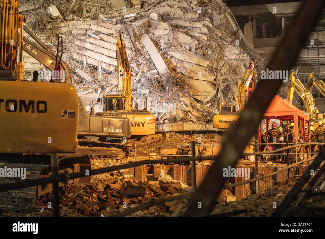 Rescue teams work tirelessly amidst the rubble of a collapsed ...