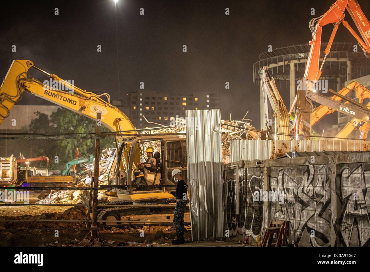 Rescue teams work tirelessly amidst the rubble of a collapsed ...