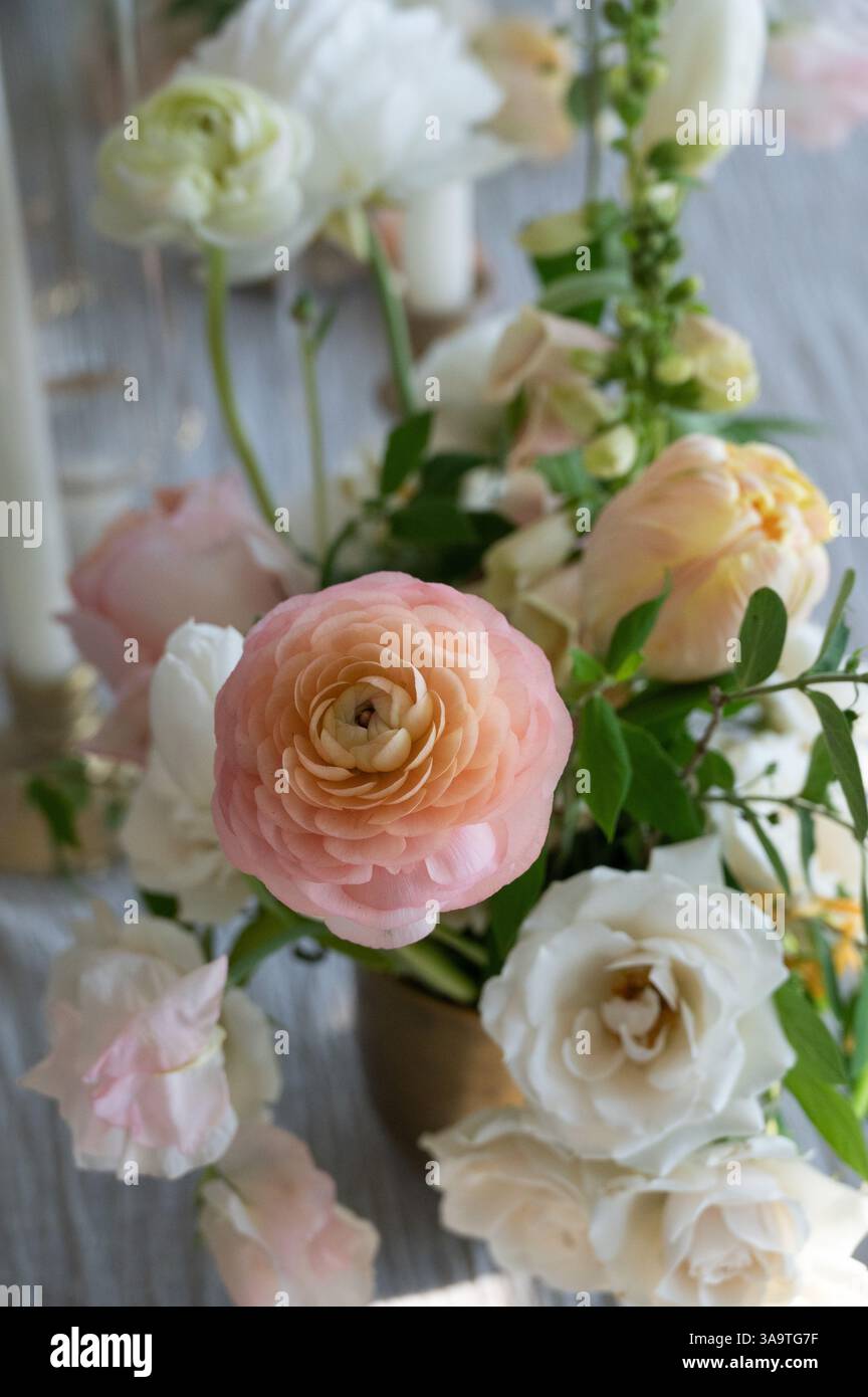 Pastel ranunculus and roses in soft floral centerpiece arrangeme Stock ...