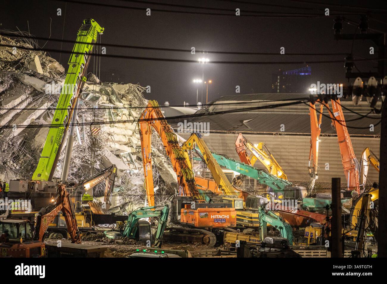 Rescue teams work tirelessly amidst the rubble of a collapsed ...