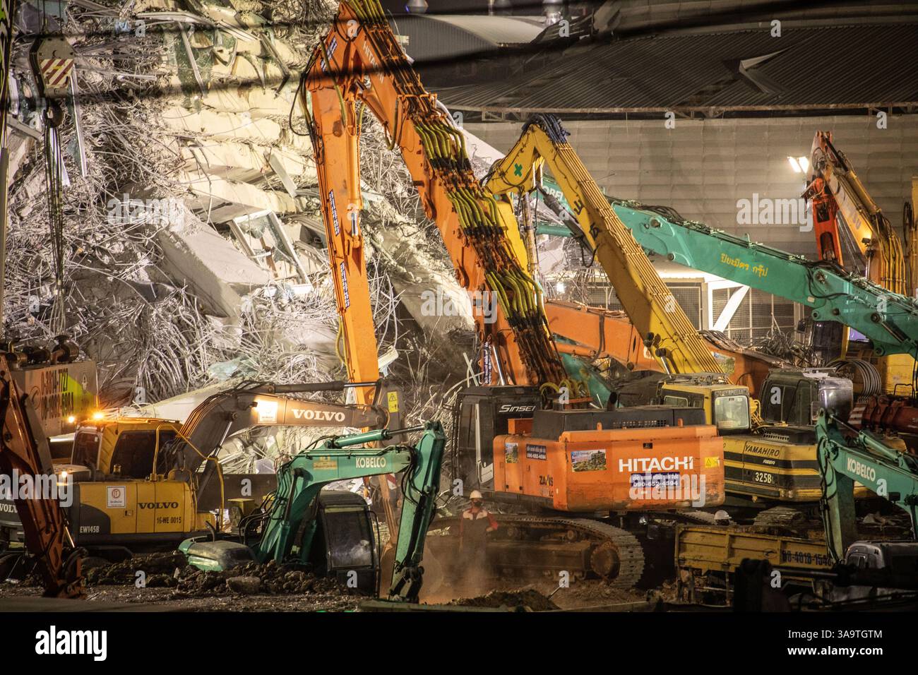 Rescue teams work tirelessly amidst the rubble of a collapsed ...