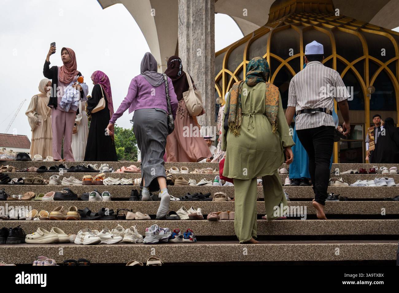 A view of Muslims climbing a staircase to arrive at the mosque ...