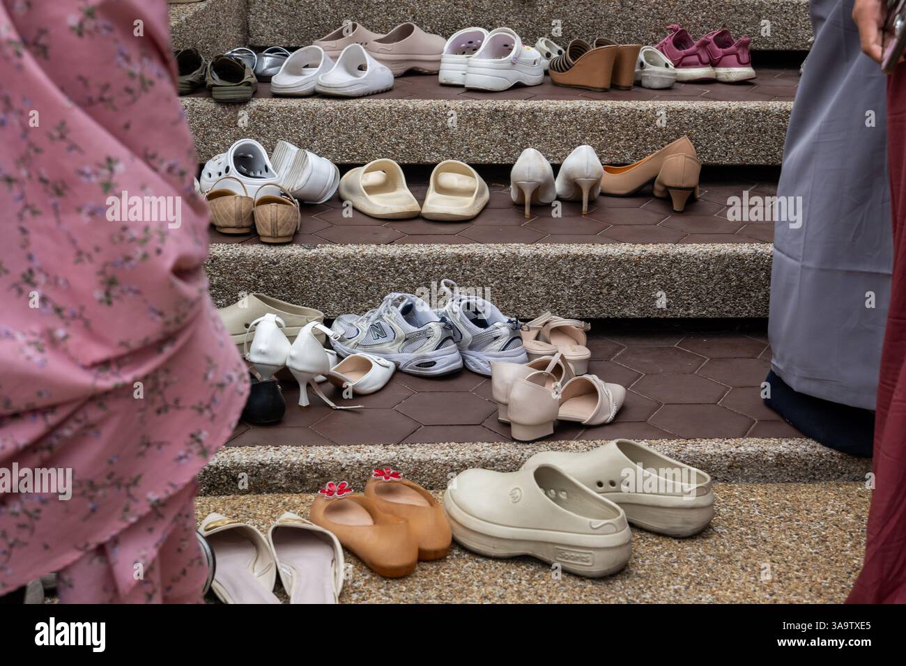 Bangkok, Thailand. 31st Mar, 2025. A close-up of prayer shoes left on ...