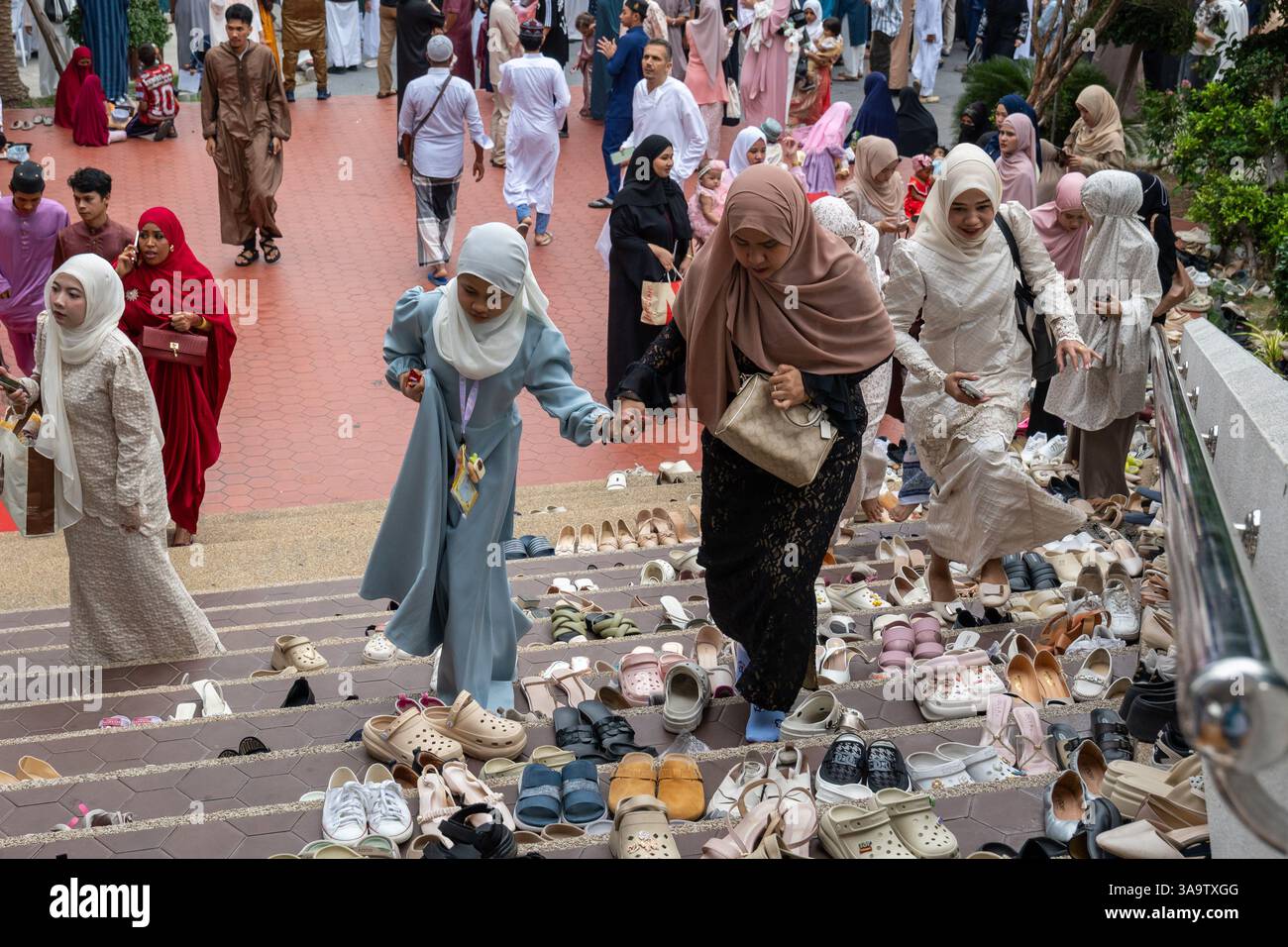 A view of Muslim women walking up the steps, trying to avoid the shoes ...