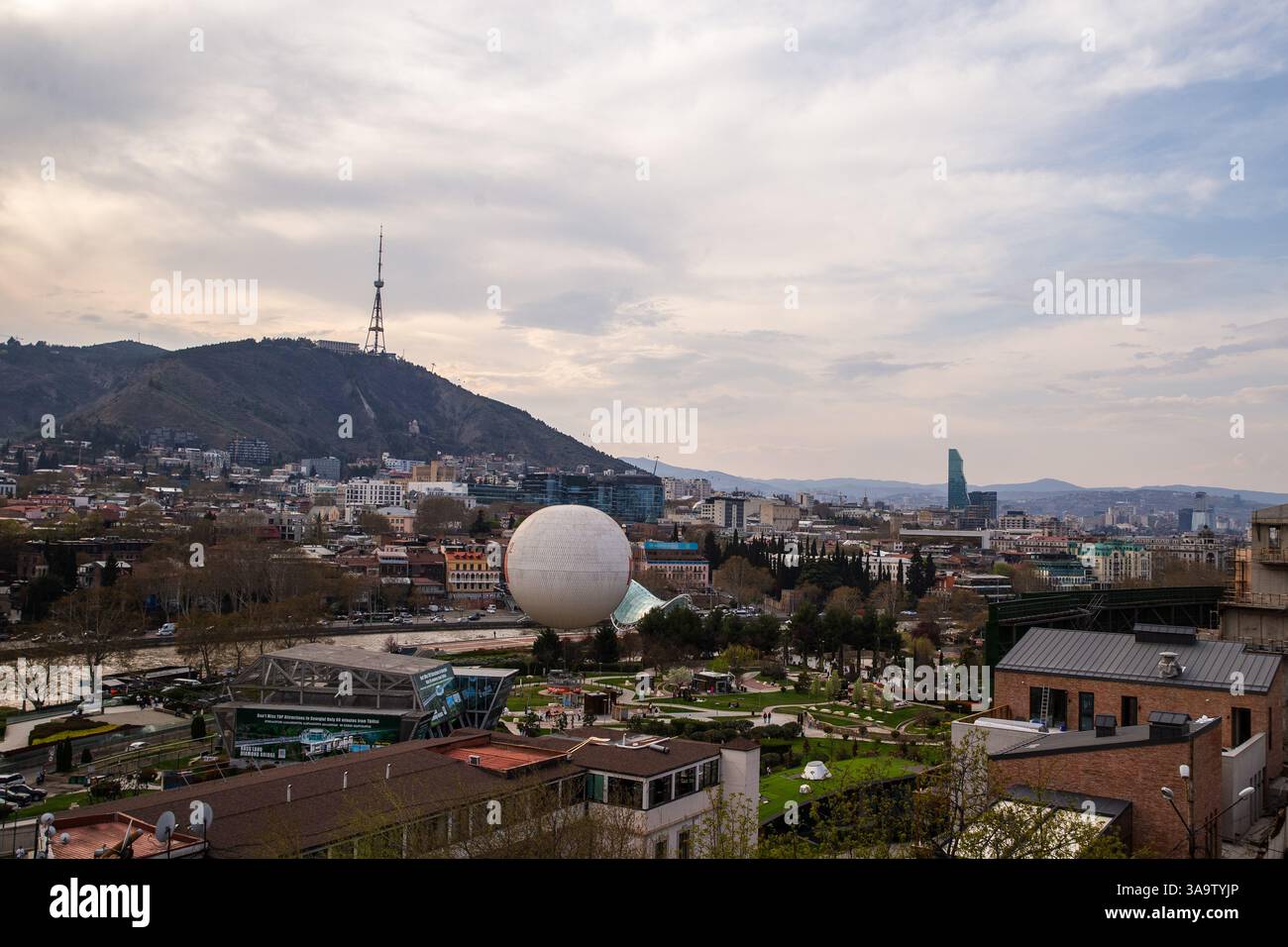 A panoramic view of the city with Rike Park, a sphere-shaped building ...