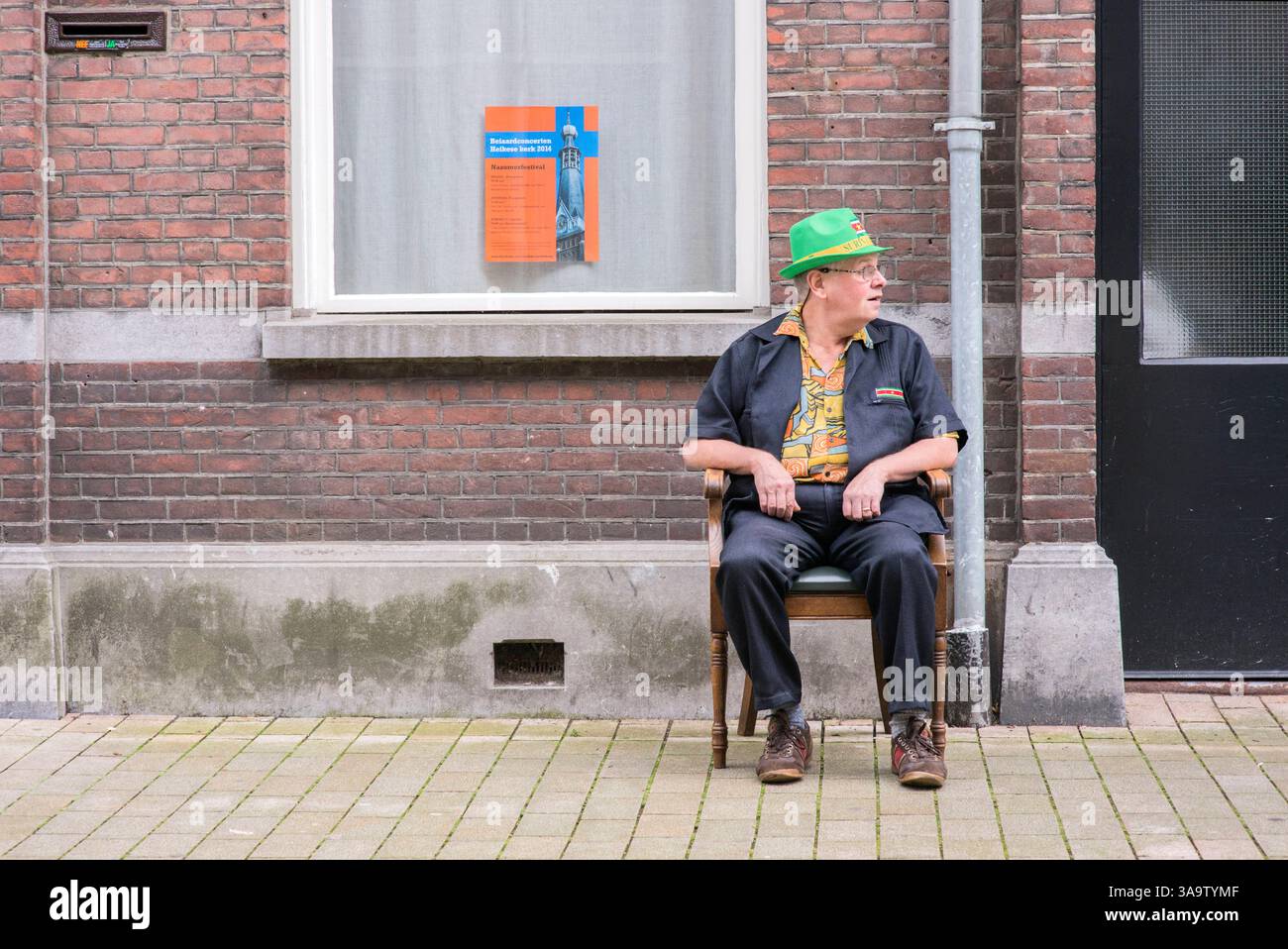 Portrait Odd Man with Chair. An elder man sitting in a chair in the ...